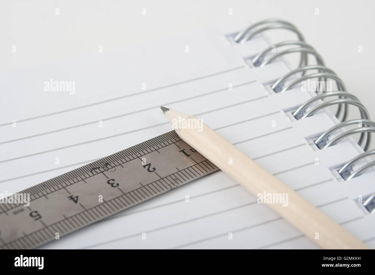 spiral note pad with a pencil and a ruler Stock Photo - Alamy