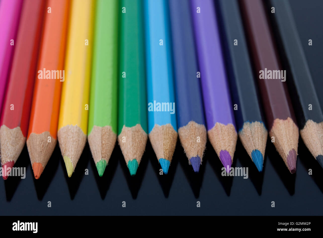 colored pencils closeup on black reflective background Stock Photo - Alamy