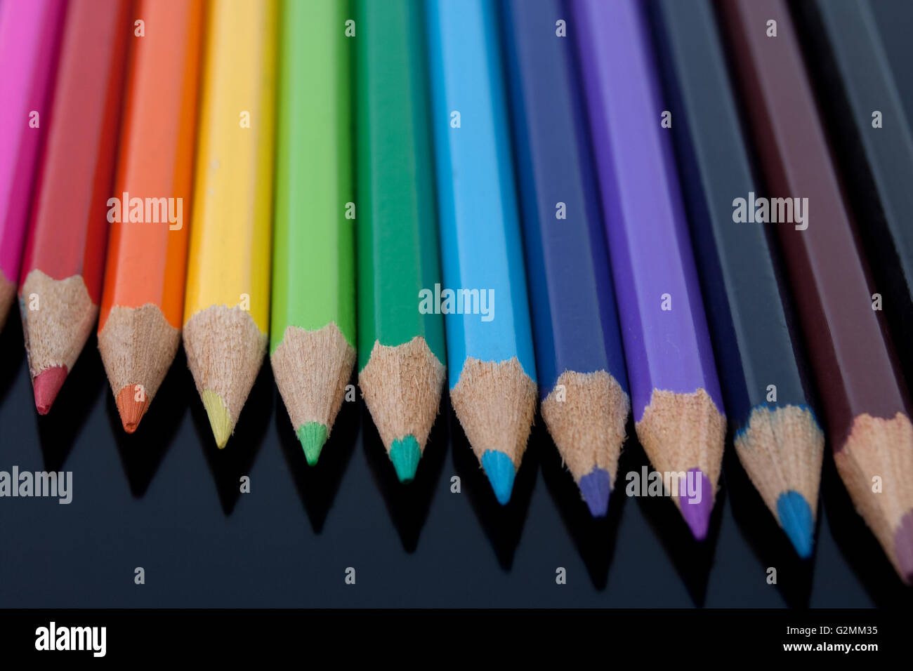 colored pencils closeup on black reflective background Stock Photo - Alamy