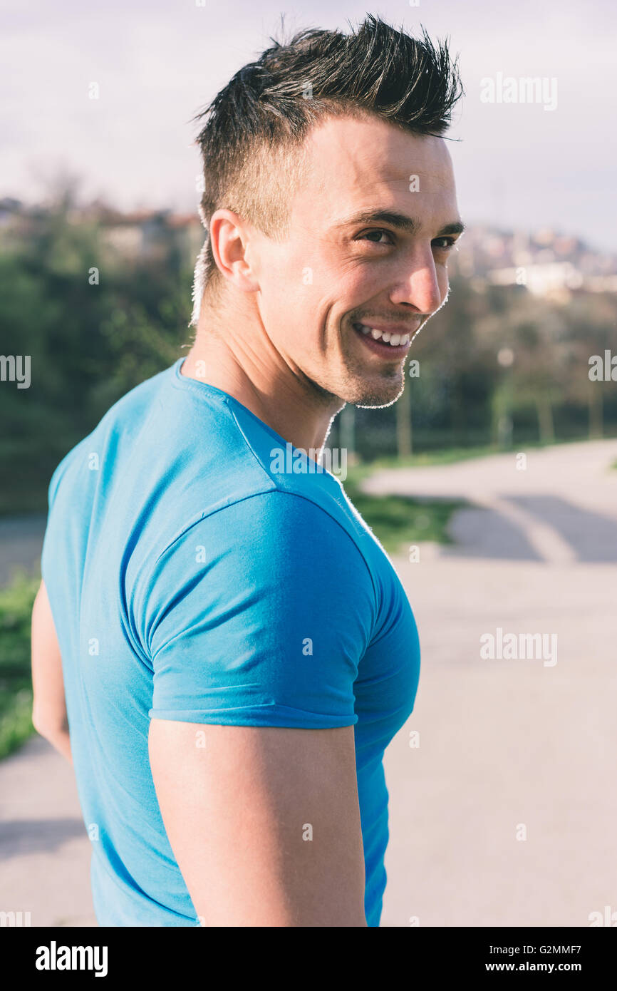 Focused handsome athlete resting after long run Stock Photo - Alamy