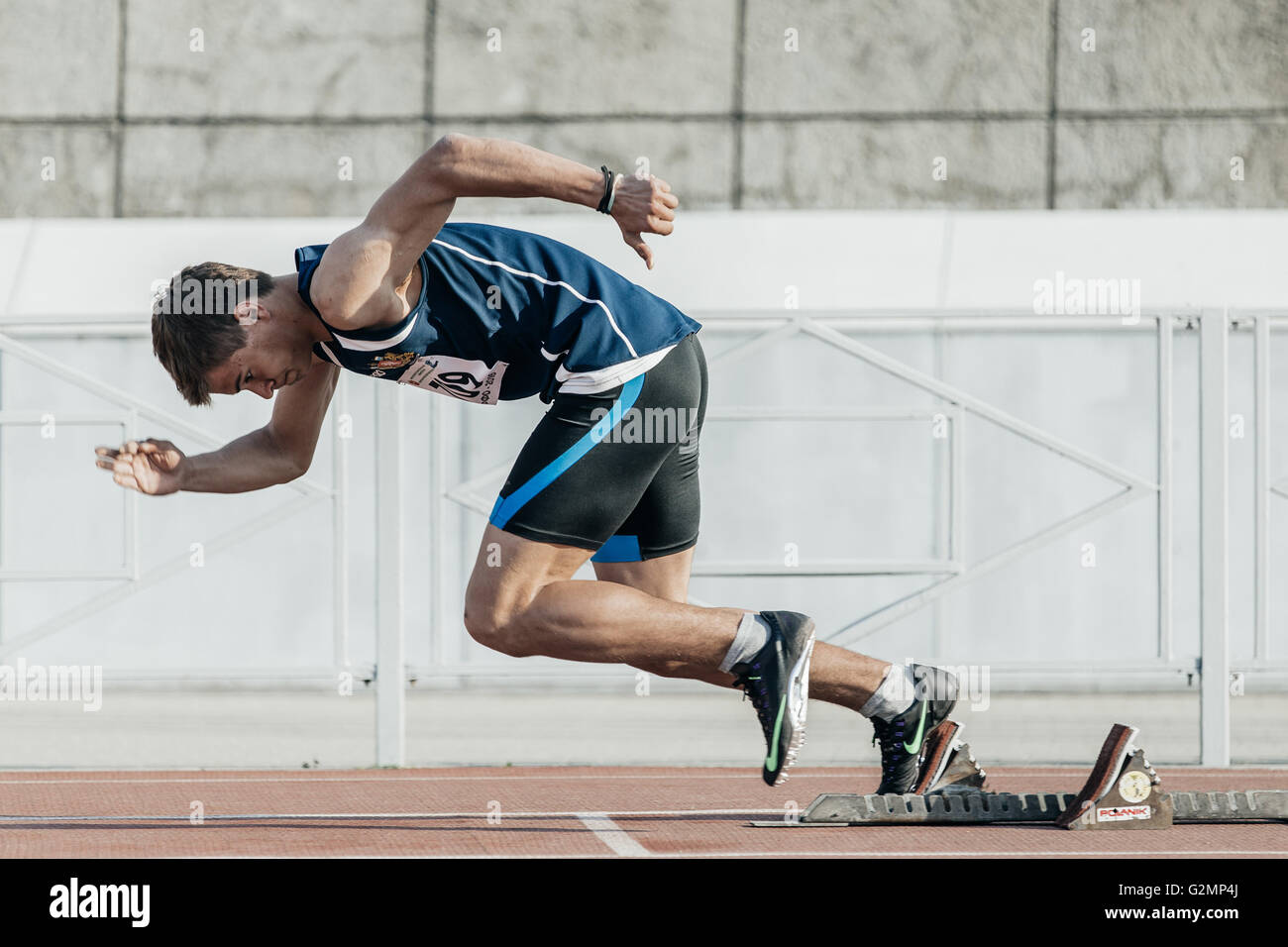 male runner starts from starting blocks on a distance of 400 meters ...