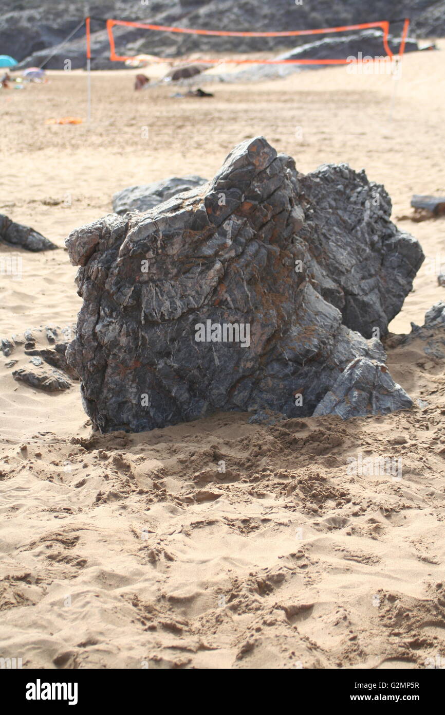 Large slate rock in the sand on the beach Stock Photo - Alamy