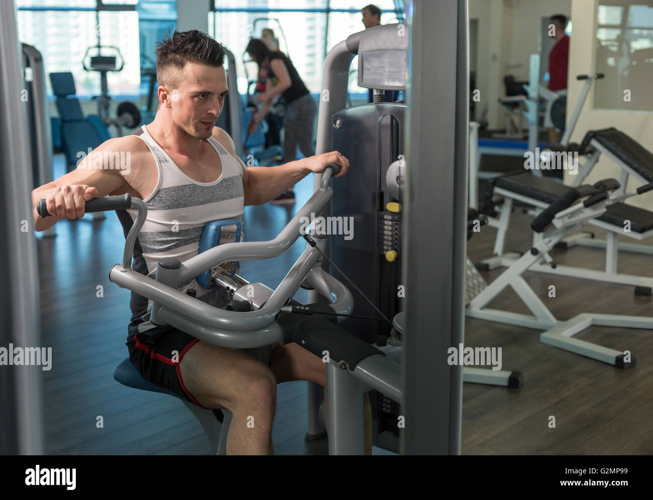 Man using chest exercise machine hi-res stock photography and images ...