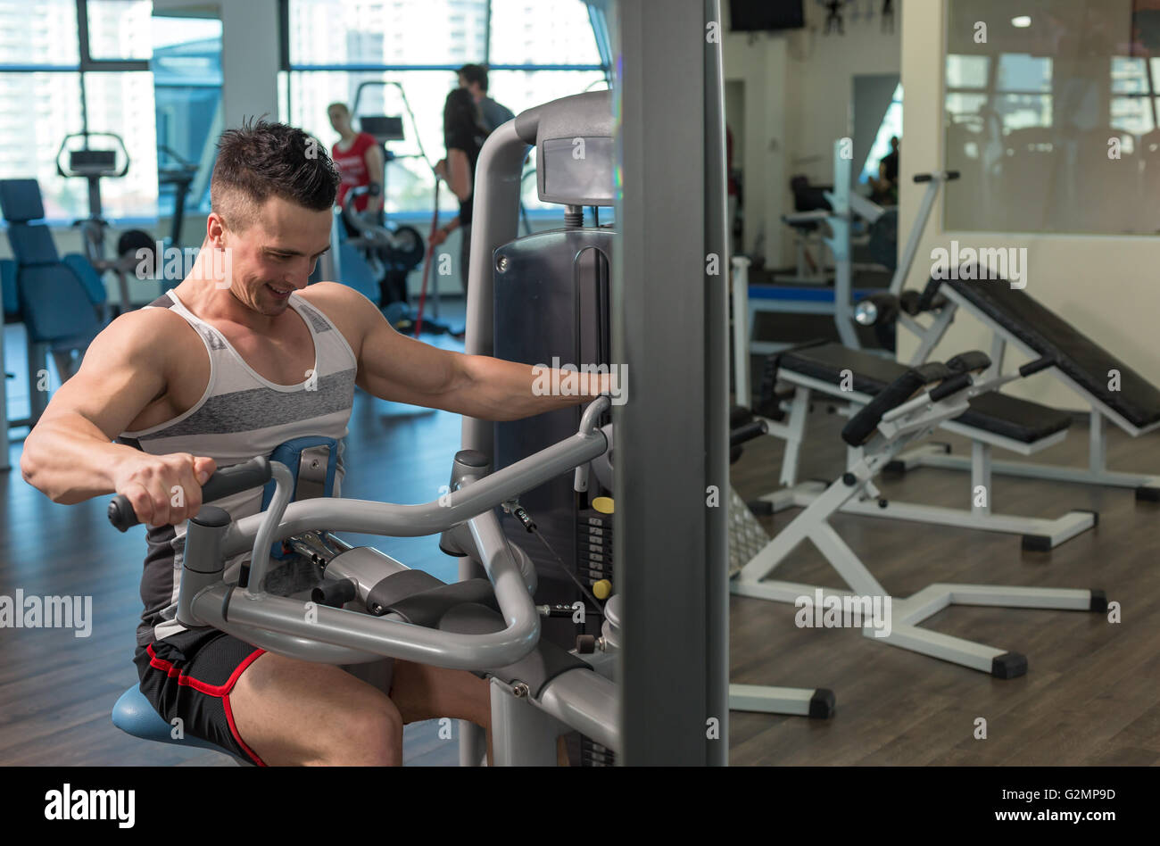 Man Using Weights Machine In Gym Stock Photo - Alamy