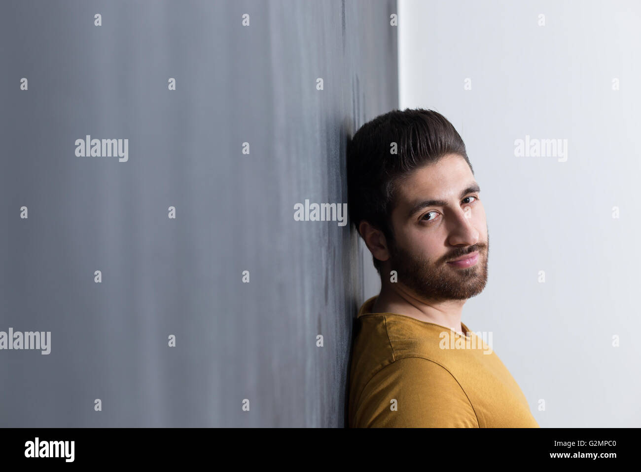 Handsome young man smiling on black background. Studio shot Stock Photo ...