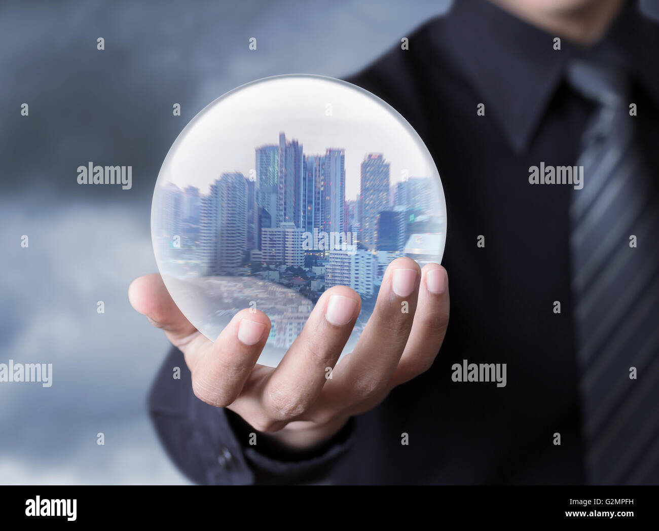 Business man holding a city inside a sphere, City of the future Stock ...