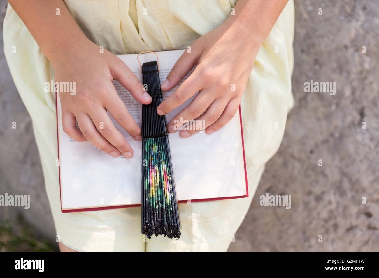 Close-up of female hands holding open book. Reading concept background ...