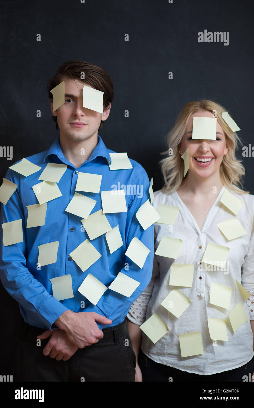 Puzzled business team looking post its on the wall in the office Stock ...