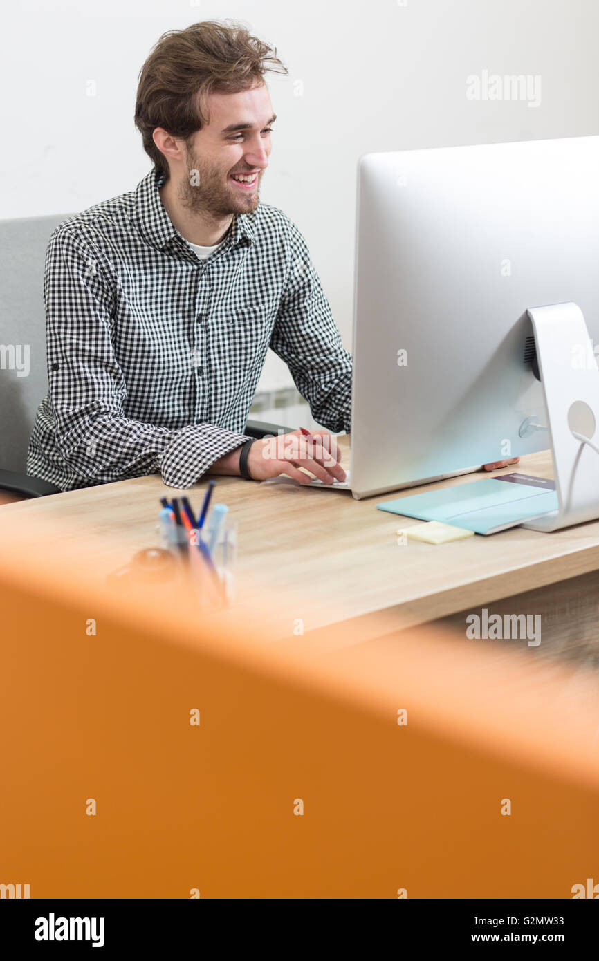 Man looking at a computer screen, thinking about the job at hand Stock ...