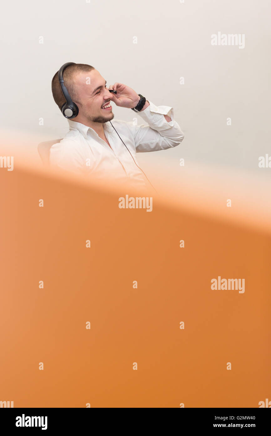 Smiling assistant using a headset in a call center Stock Photo - Alamy