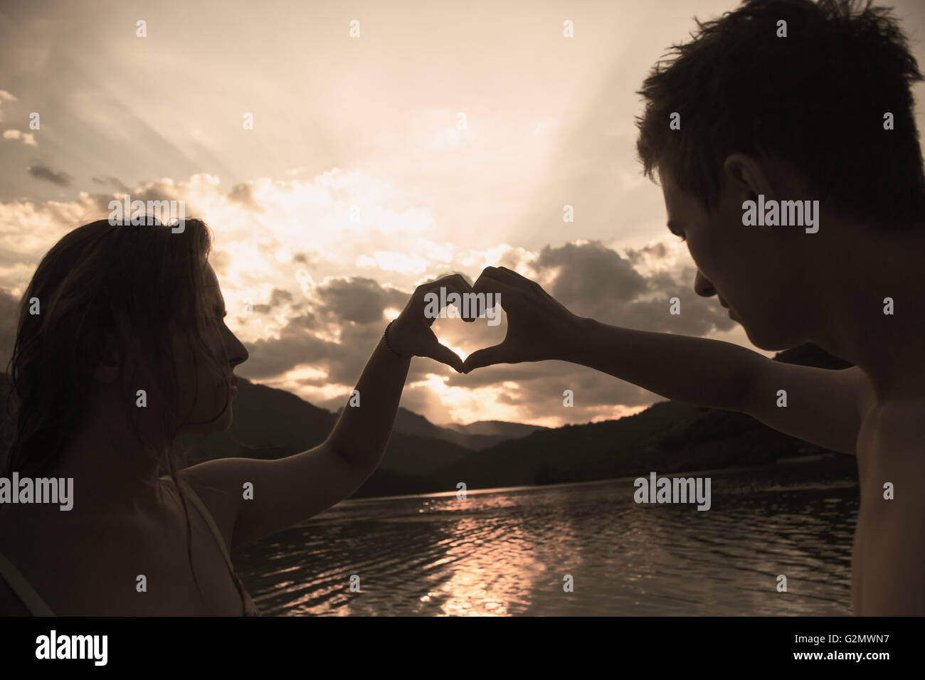 Girl making heart shape arms hi-res stock photography and images - Alamy