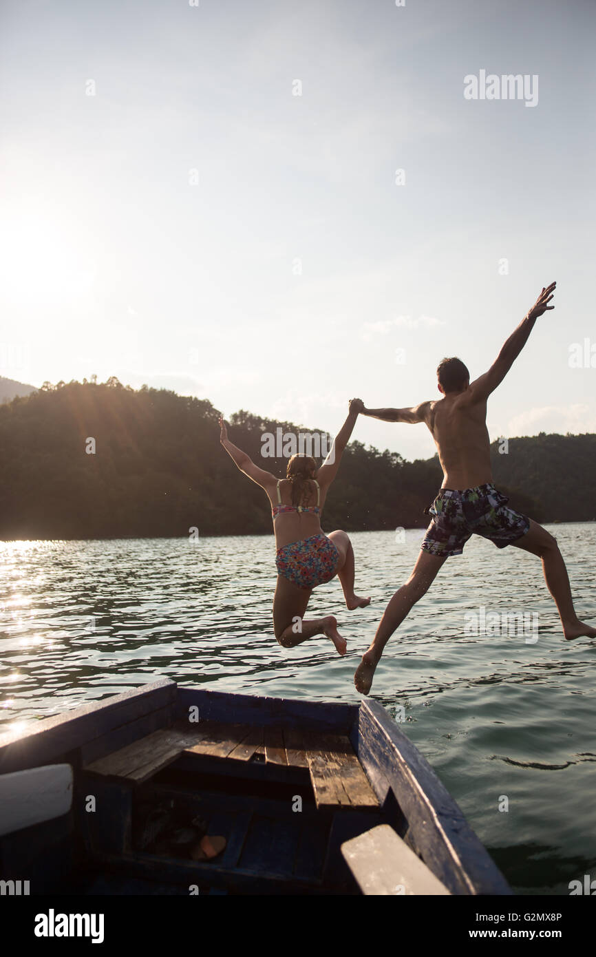Couple jumping boat hi-res stock photography and images - Alamy