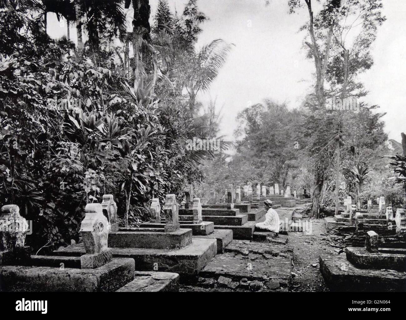Photograph shows an Indonesian graveyard situated in a forest. Dutch ...