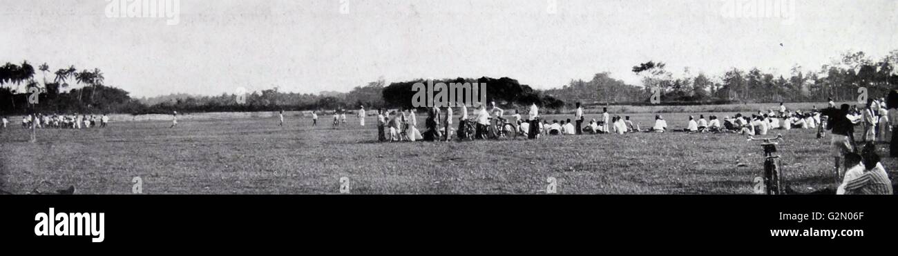 Photograph shows a group of villagers being taught how to hunt with a ...