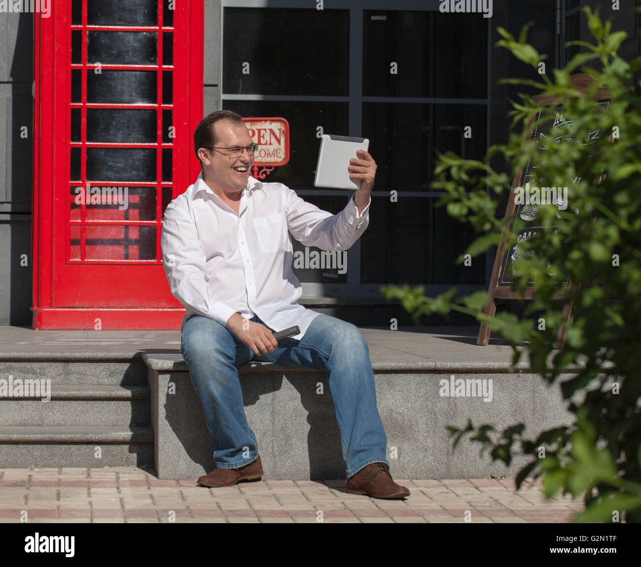 Business man using mobile phone red classic English telephone box Stock ...