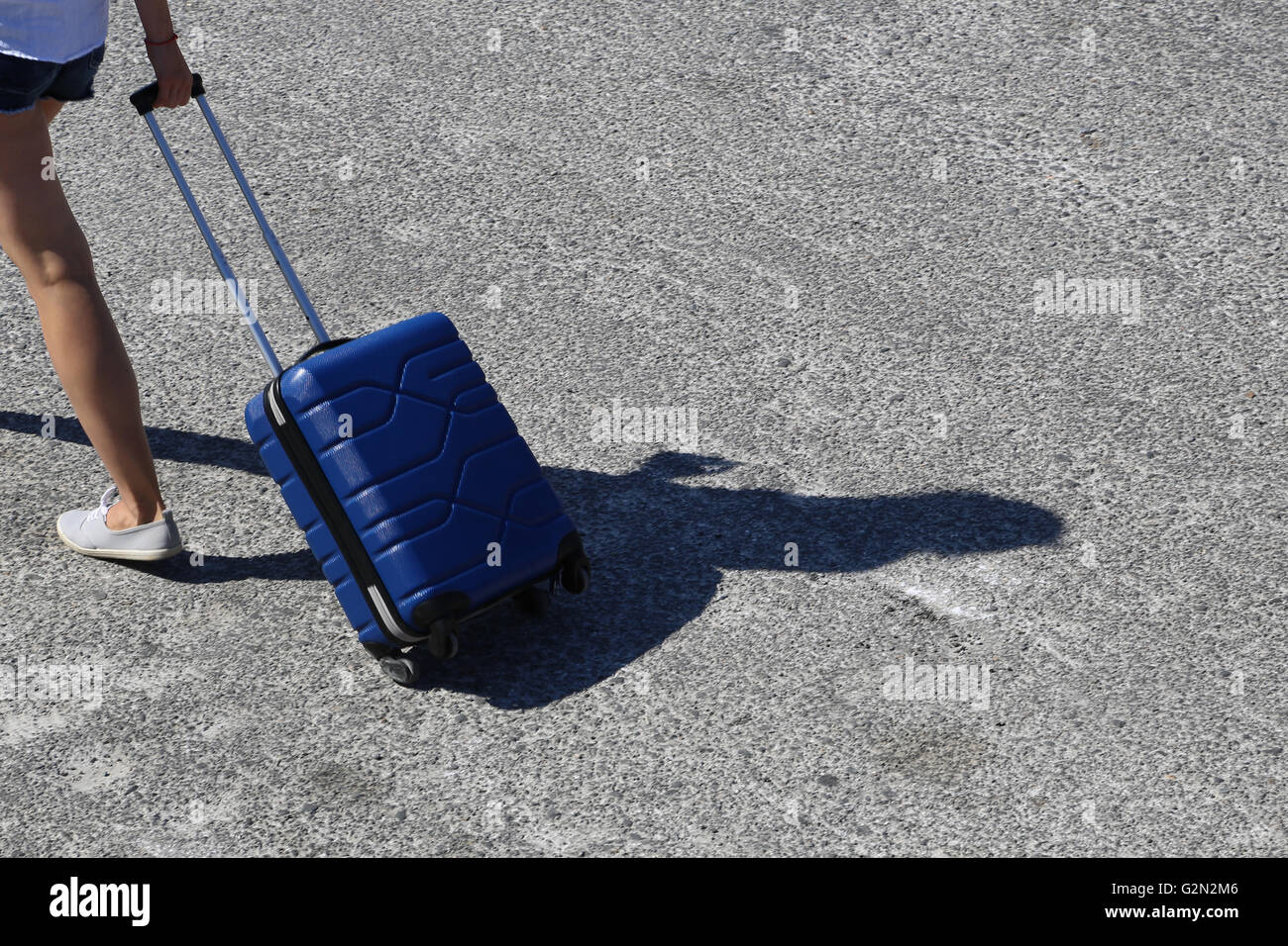 Legs of young woman with baggage in harbor Stock Photo - Alamy