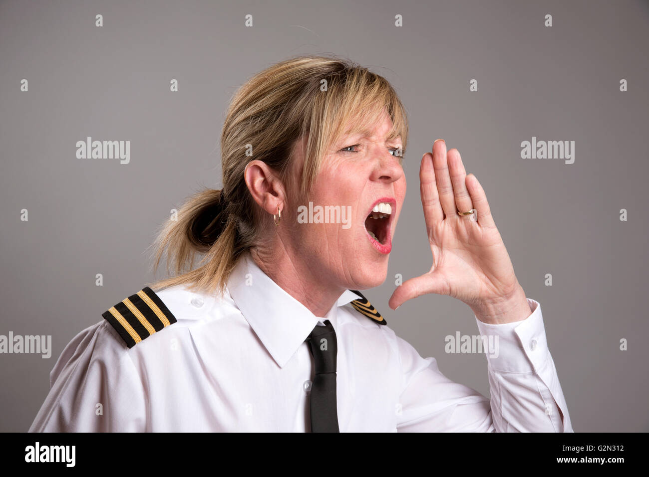OFFICER SHOUTS AN ORDER Portrait of a female uniformed officer shouting ...