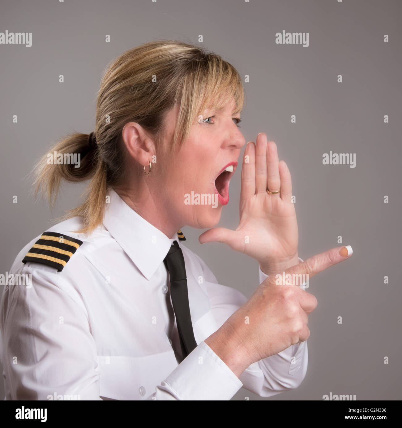 OFFICER SHOUTS AN ORDER Portrait of a female uniformed officer shouting ...