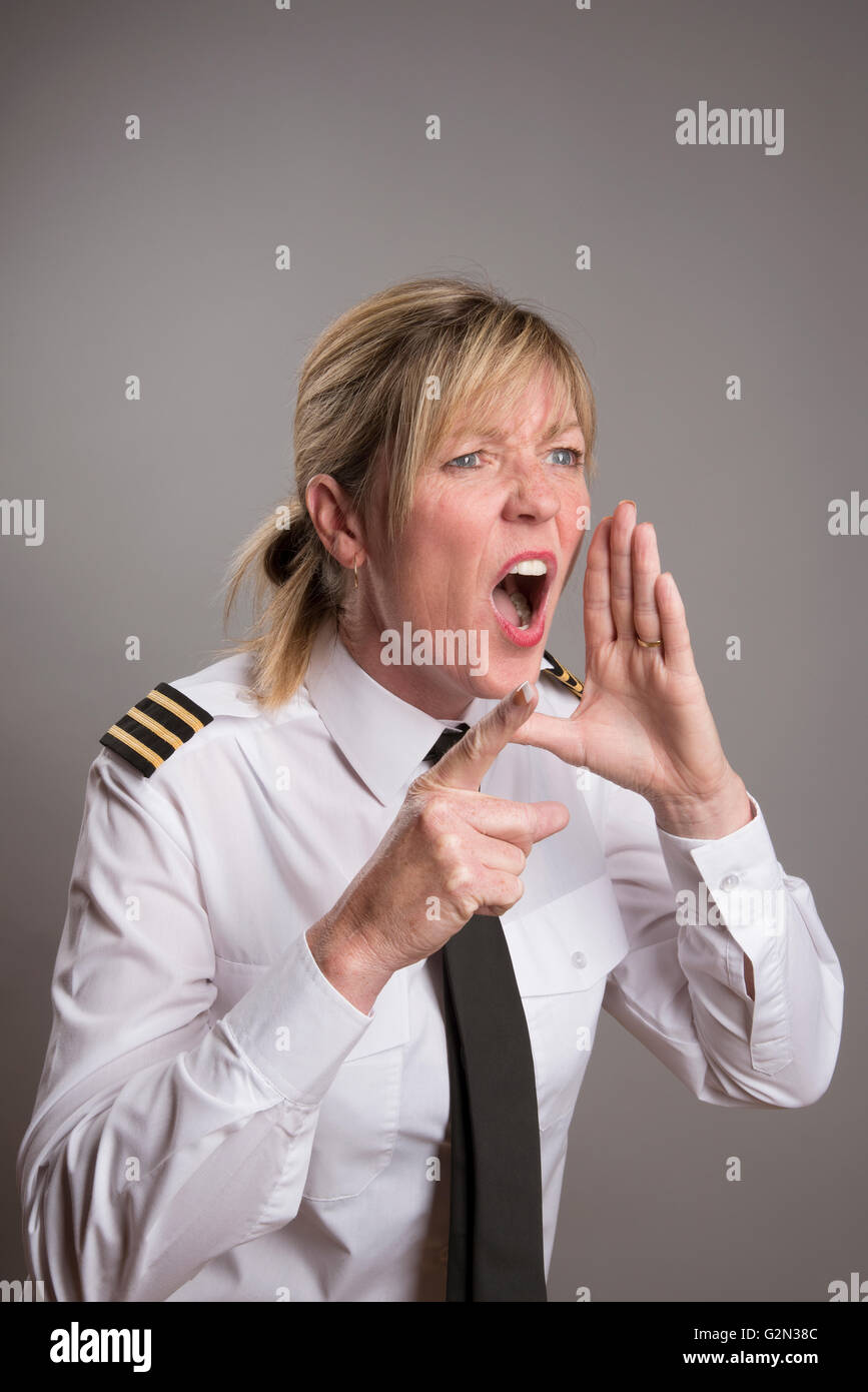 OFFICER SHOUTS AN ORDER Portrait of a female uniformed officer shouting ...