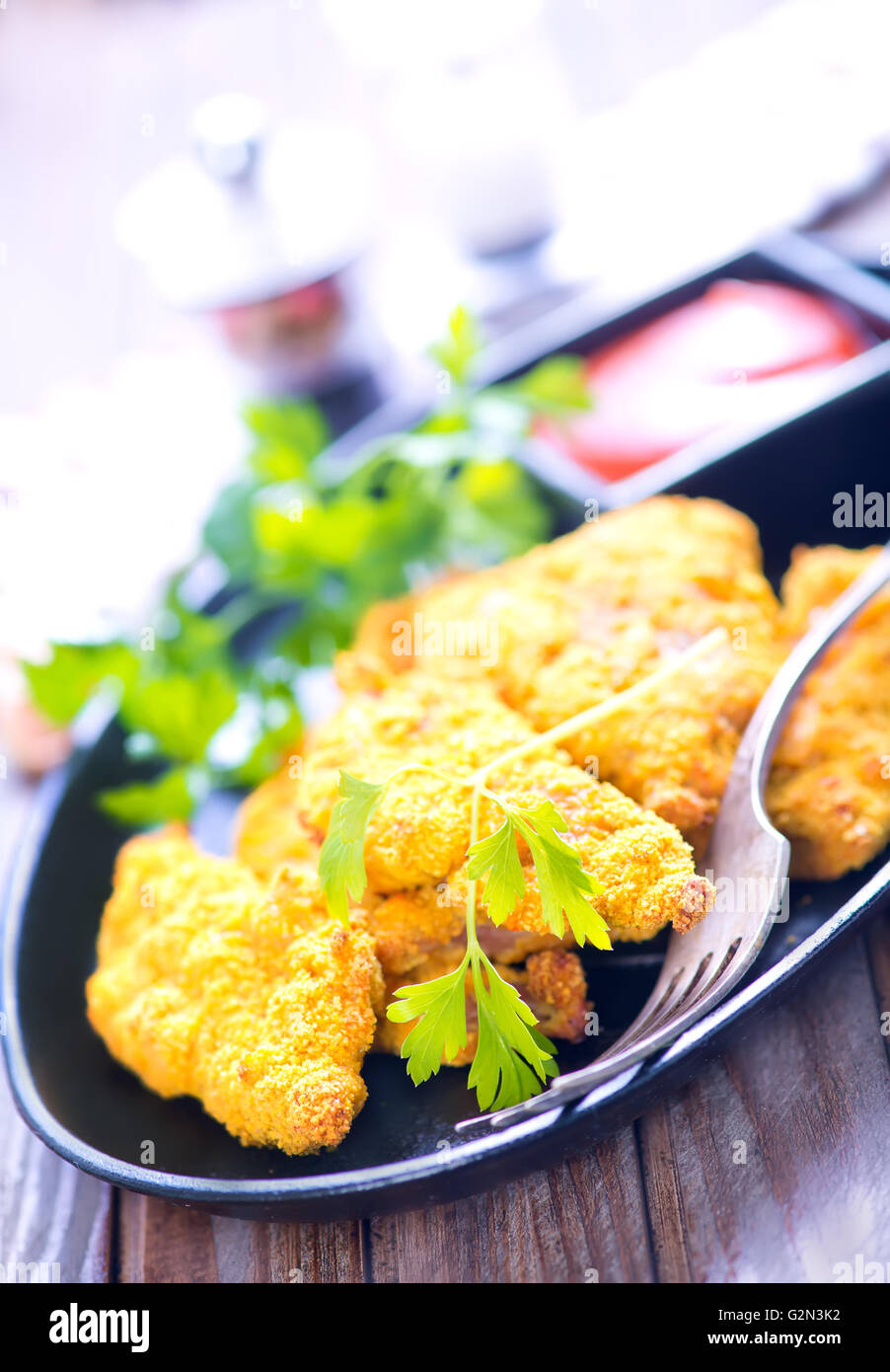 fried fish on plate and on a table Stock Photo - Alamy