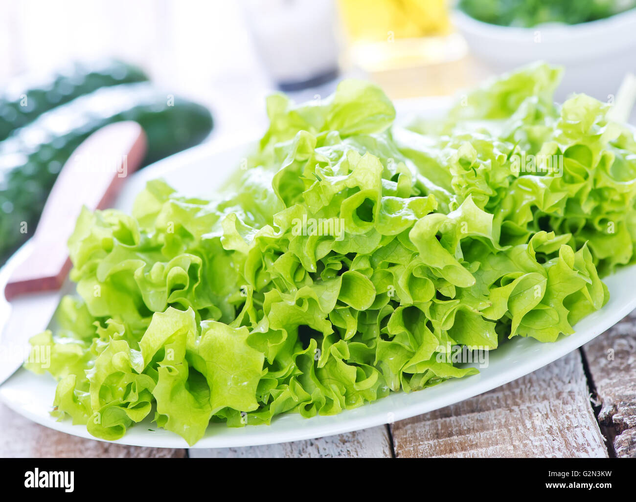 fresh lettuce on plate and on a table Stock Photo - Alamy