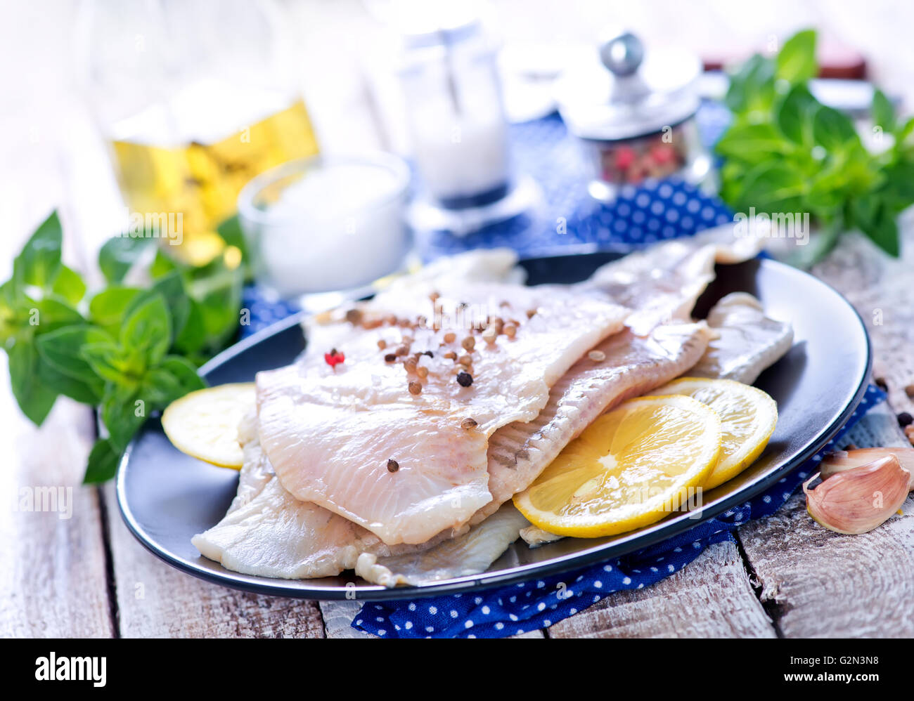 raw fish with aroma spice and fresh lemon Stock Photo - Alamy