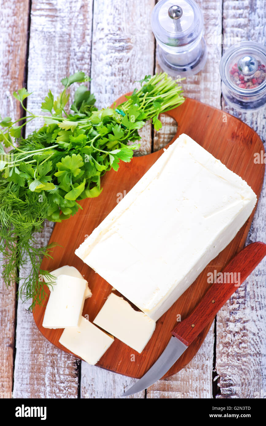 fresh butter on board and on a table Stock Photo - Alamy