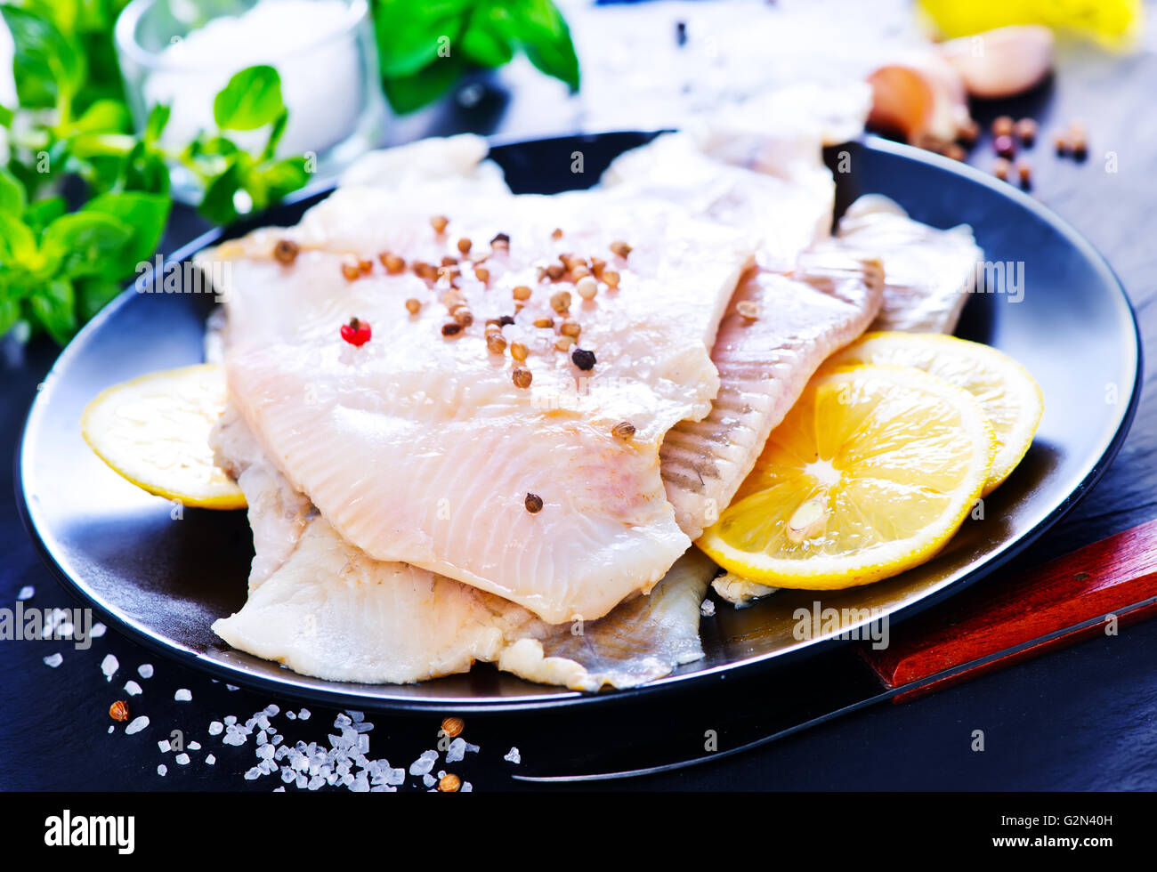 raw fish with aroma spice and fresh lemon Stock Photo - Alamy