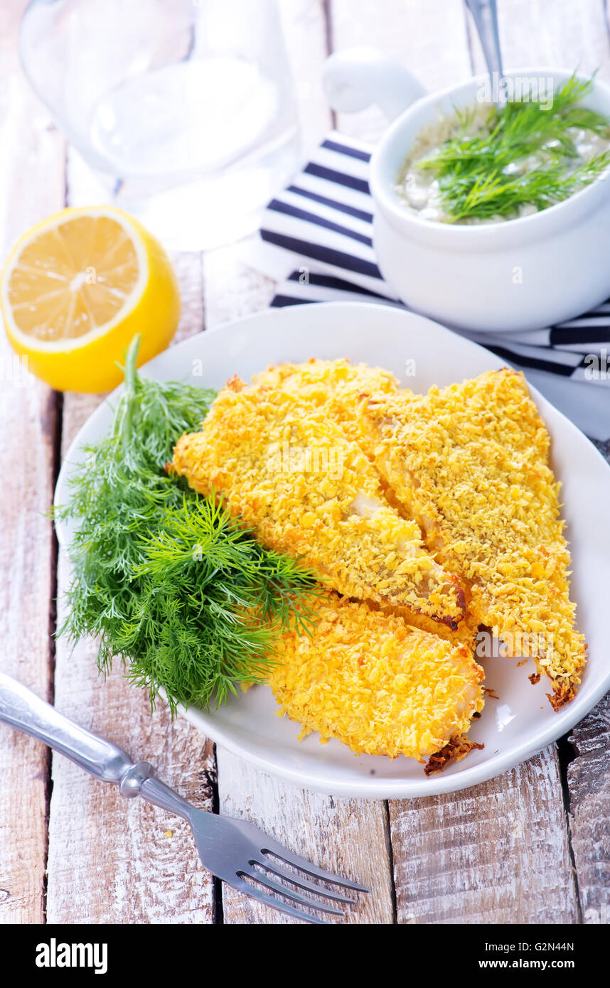 fried fish on plate and on a table Stock Photo - Alamy
