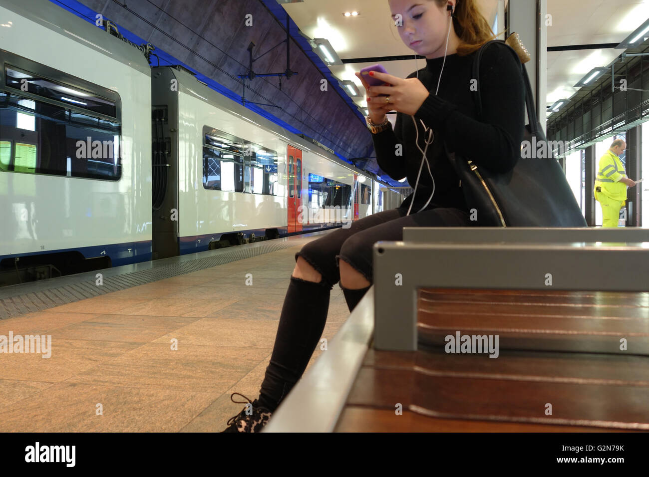 checking mobile phone at Antwerp railway station Stock Photo - Alamy