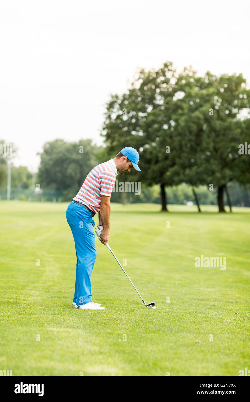 Young man playing golf at the golf court Stock Photo - Alamy