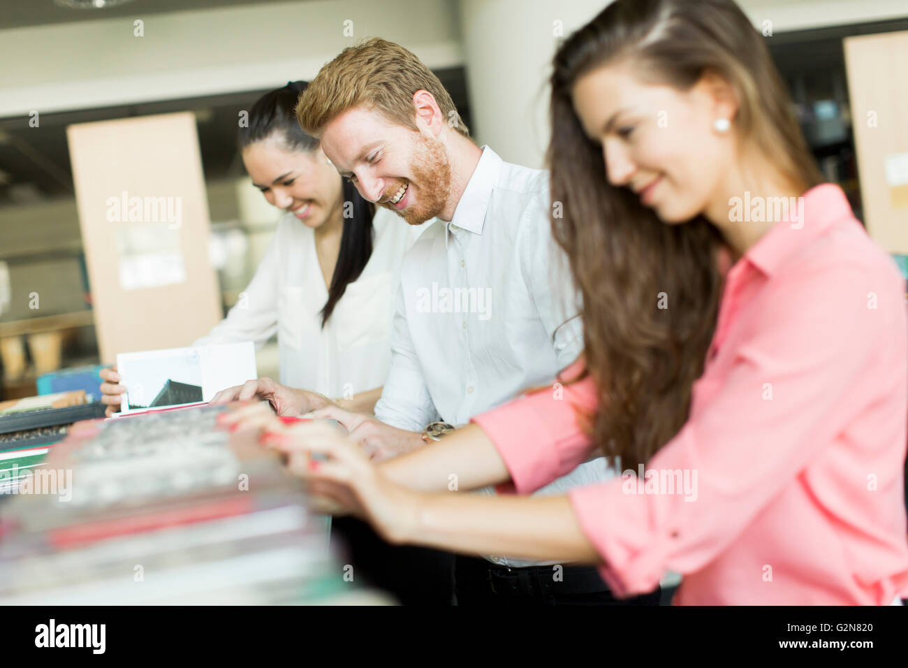 People standing by the bookshelves in the library Stock Photo - Alamy