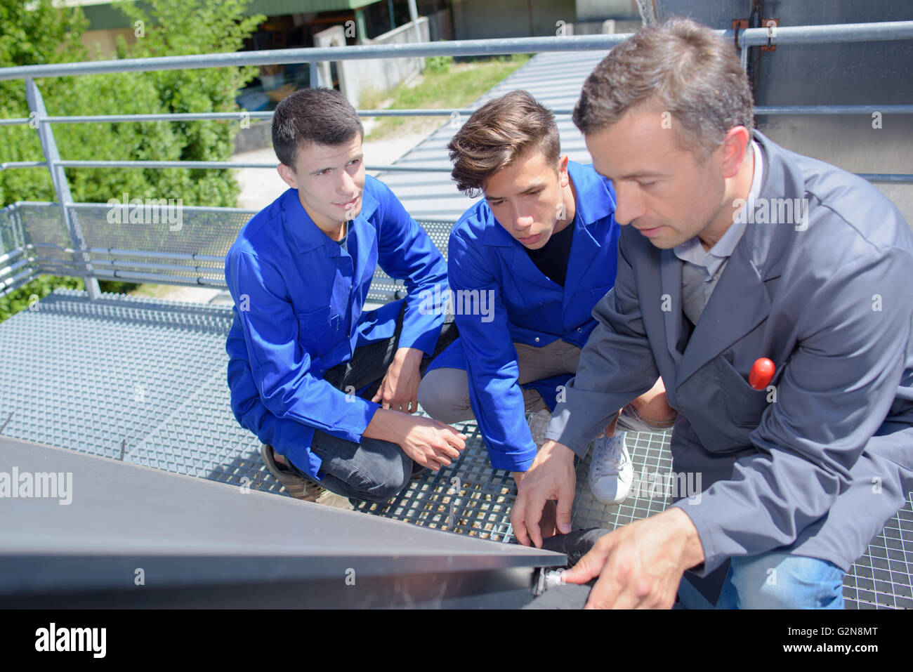 Man showing solar panel to students Stock Photo - Alamy