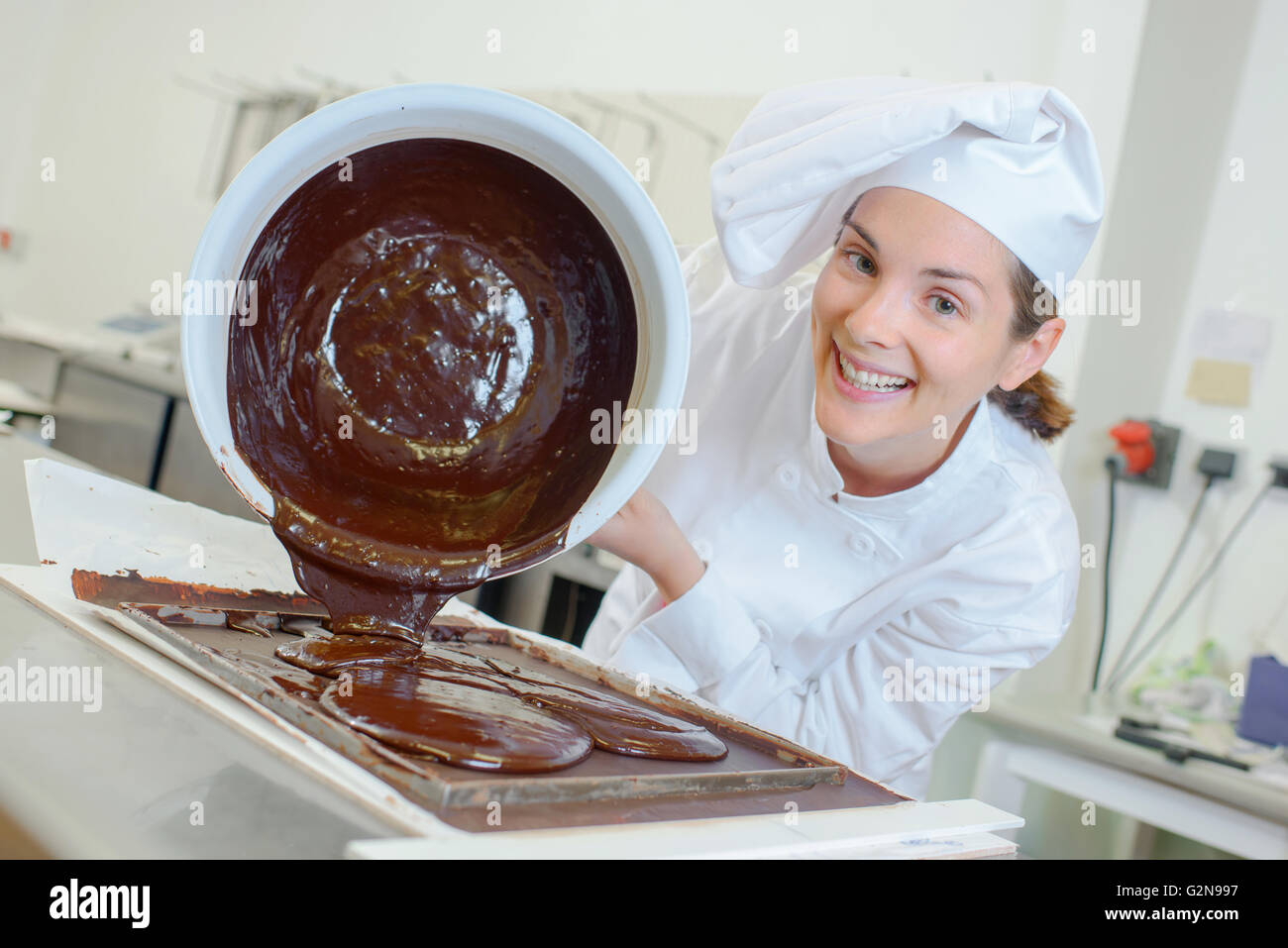 Woman pouring chocolate ganache hi-res stock photography and images - Alamy