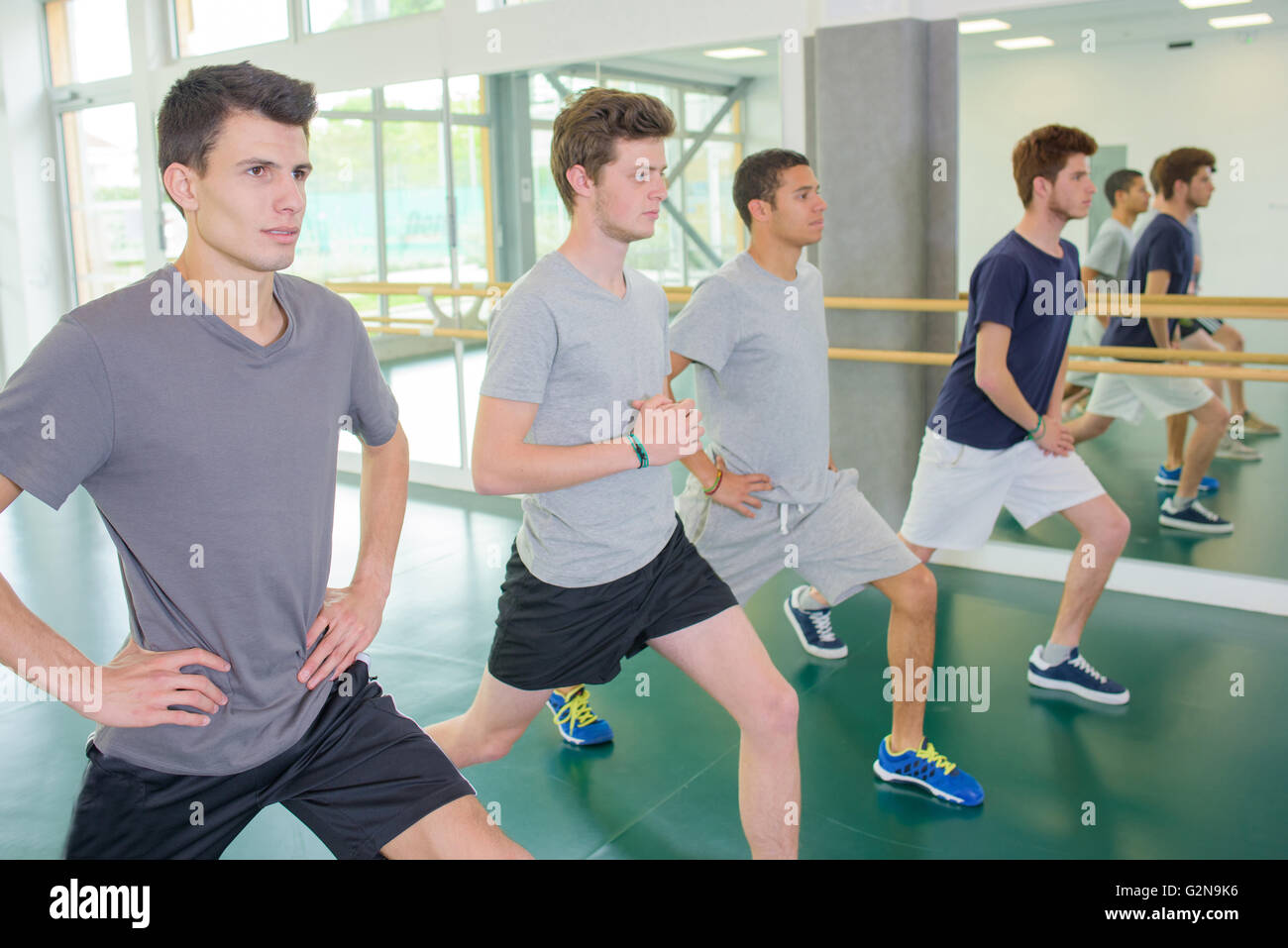 Four young men exercising in gym Stock Photo - Alamy