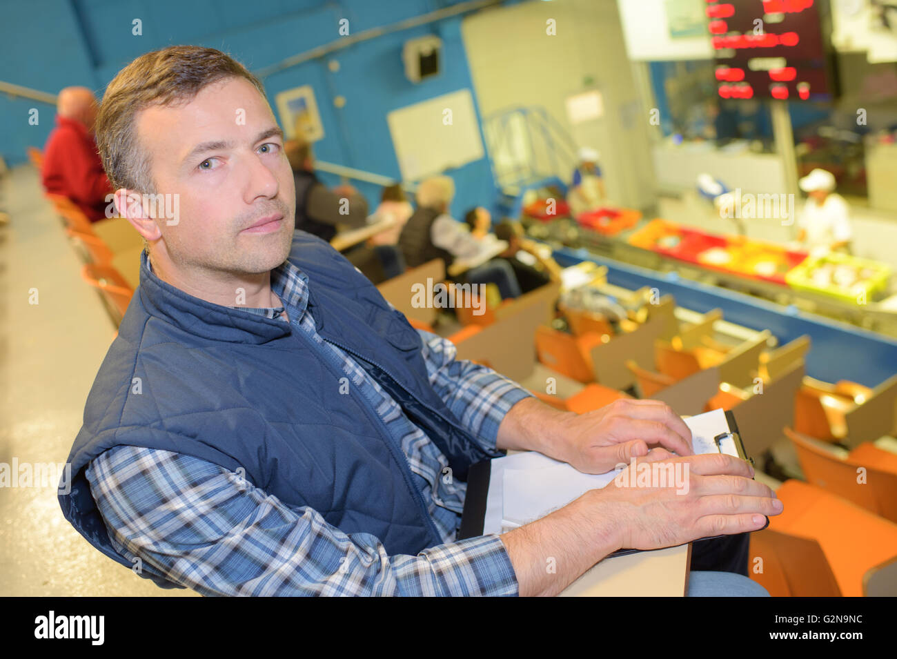 Man in auction house Stock Photo - Alamy