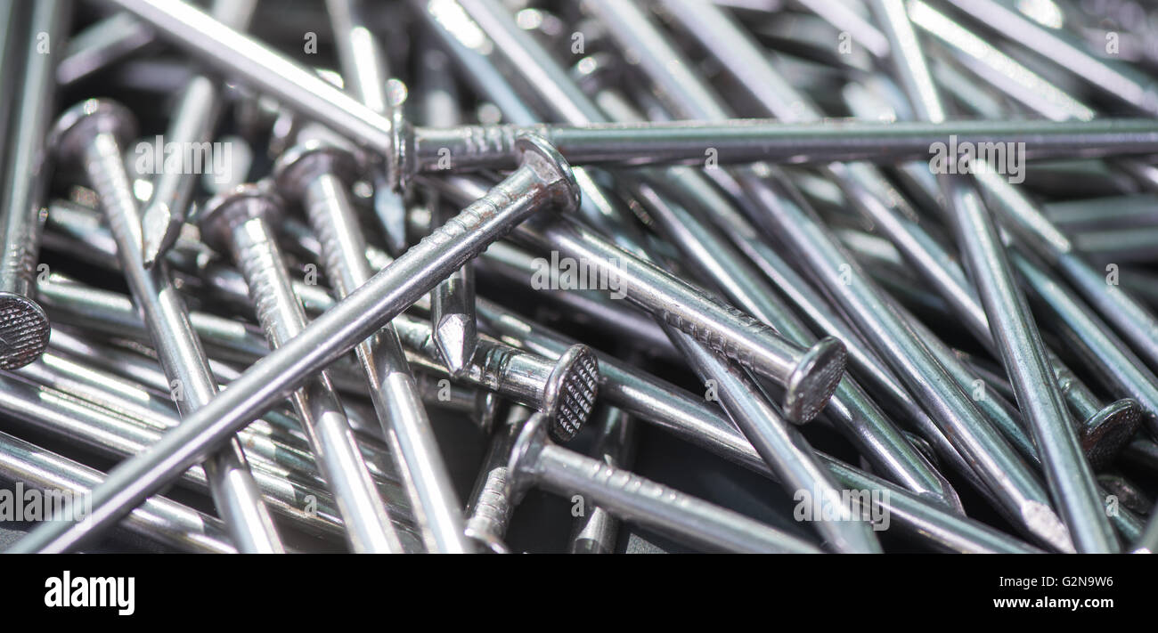 Carpenter long nails on a table Stock Photo - Alamy