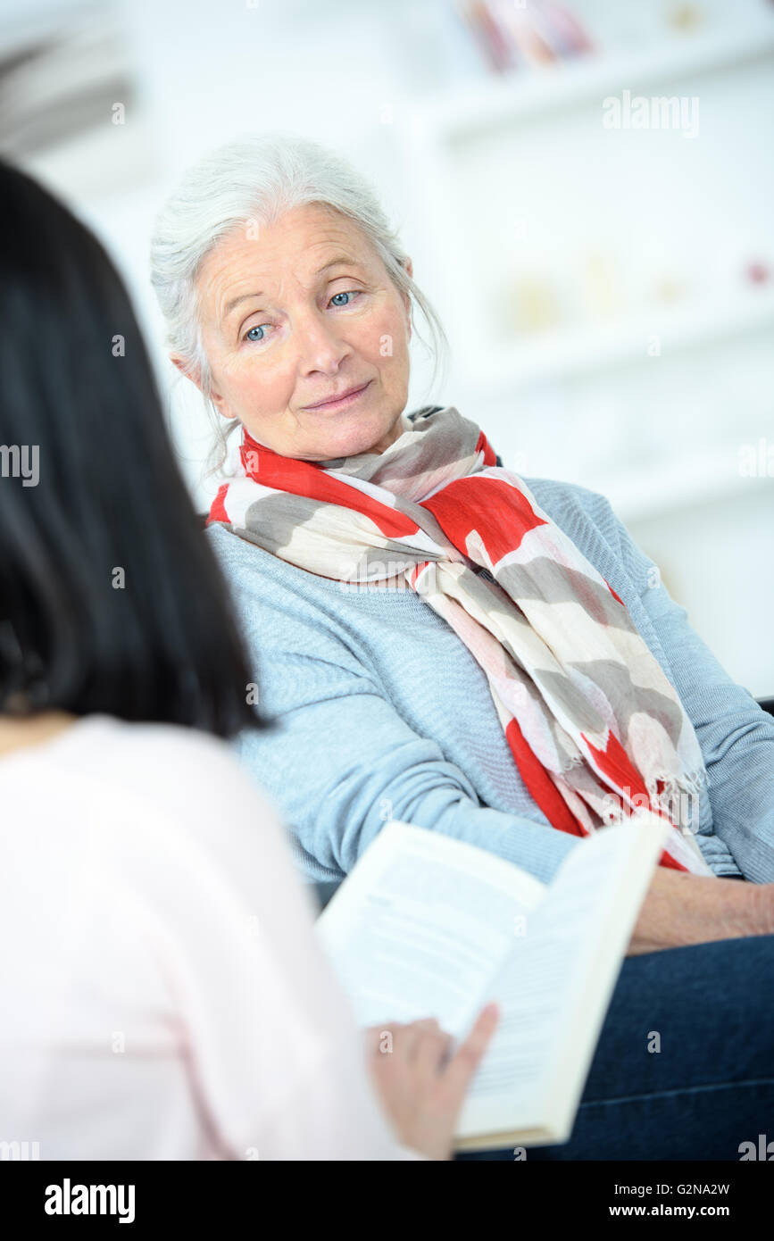 Helping senior woman to read Stock Photo - Alamy