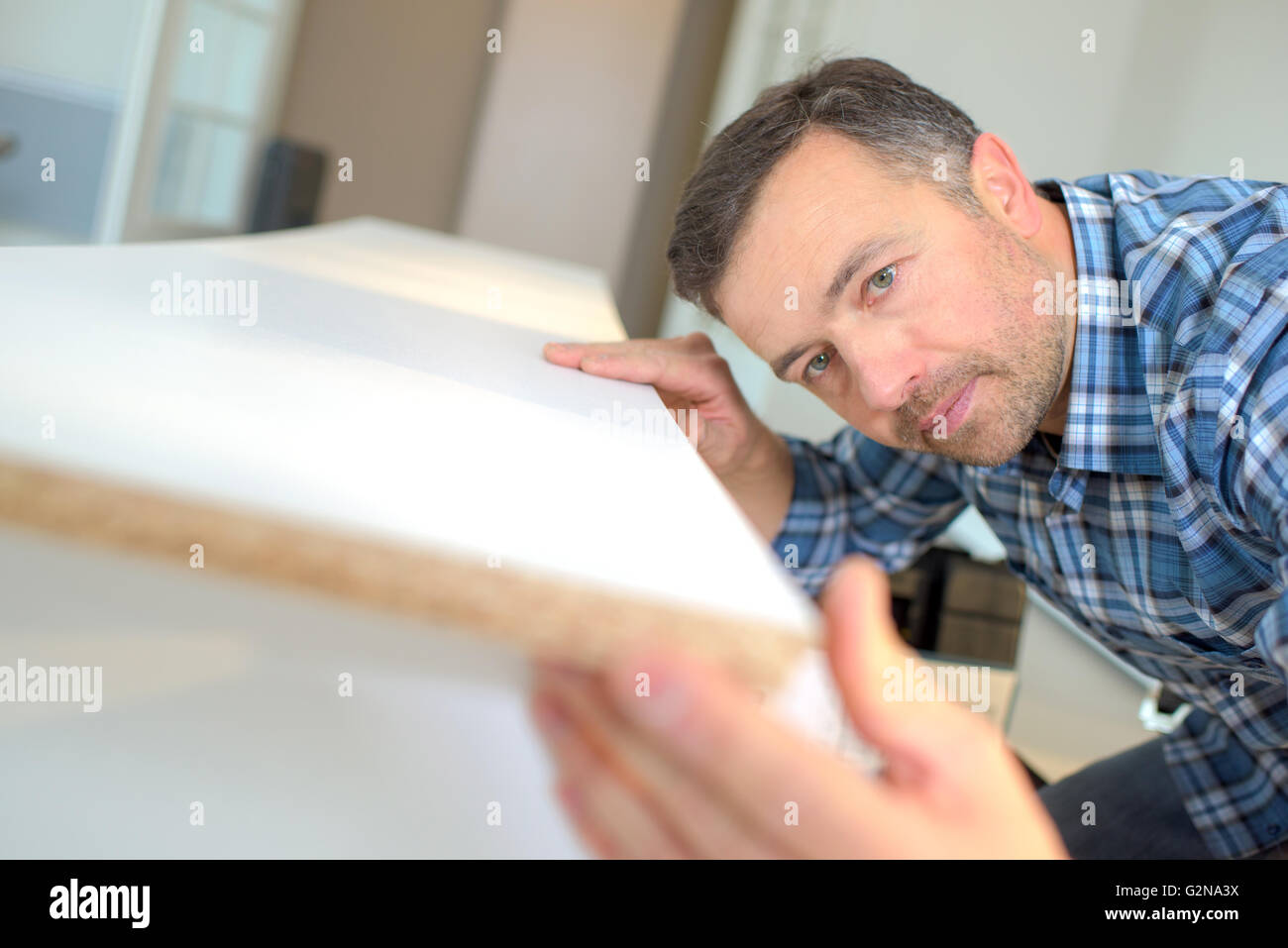 Putting together flap pack furniture Stock Photo - Alamy