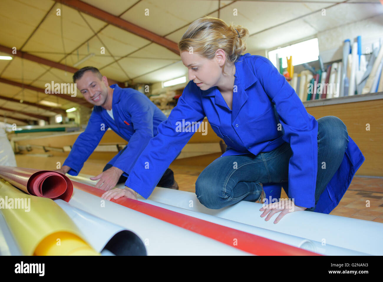 Man and woman choosing roll of material Stock Photo - Alamy