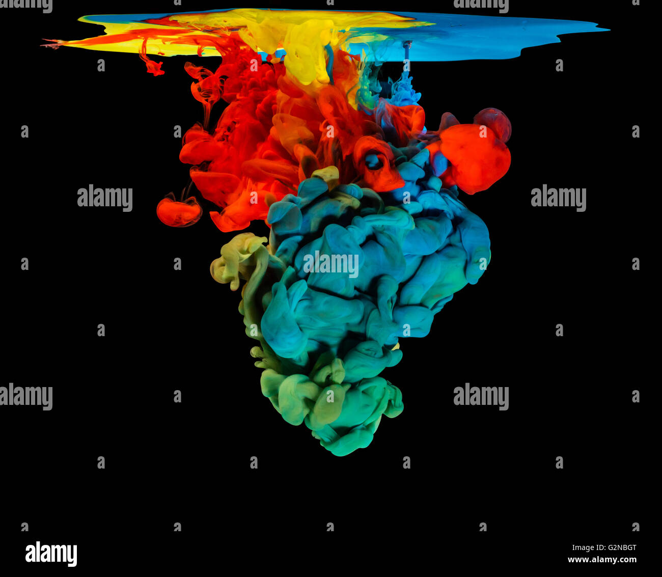 Mix of colored ink in water creating abstract shape, isolated on black ...