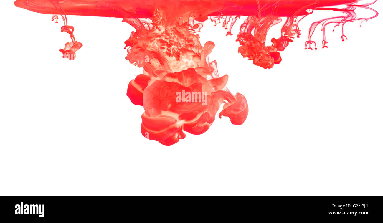 Colored ink in water creating abstract shape, isolated on white ...