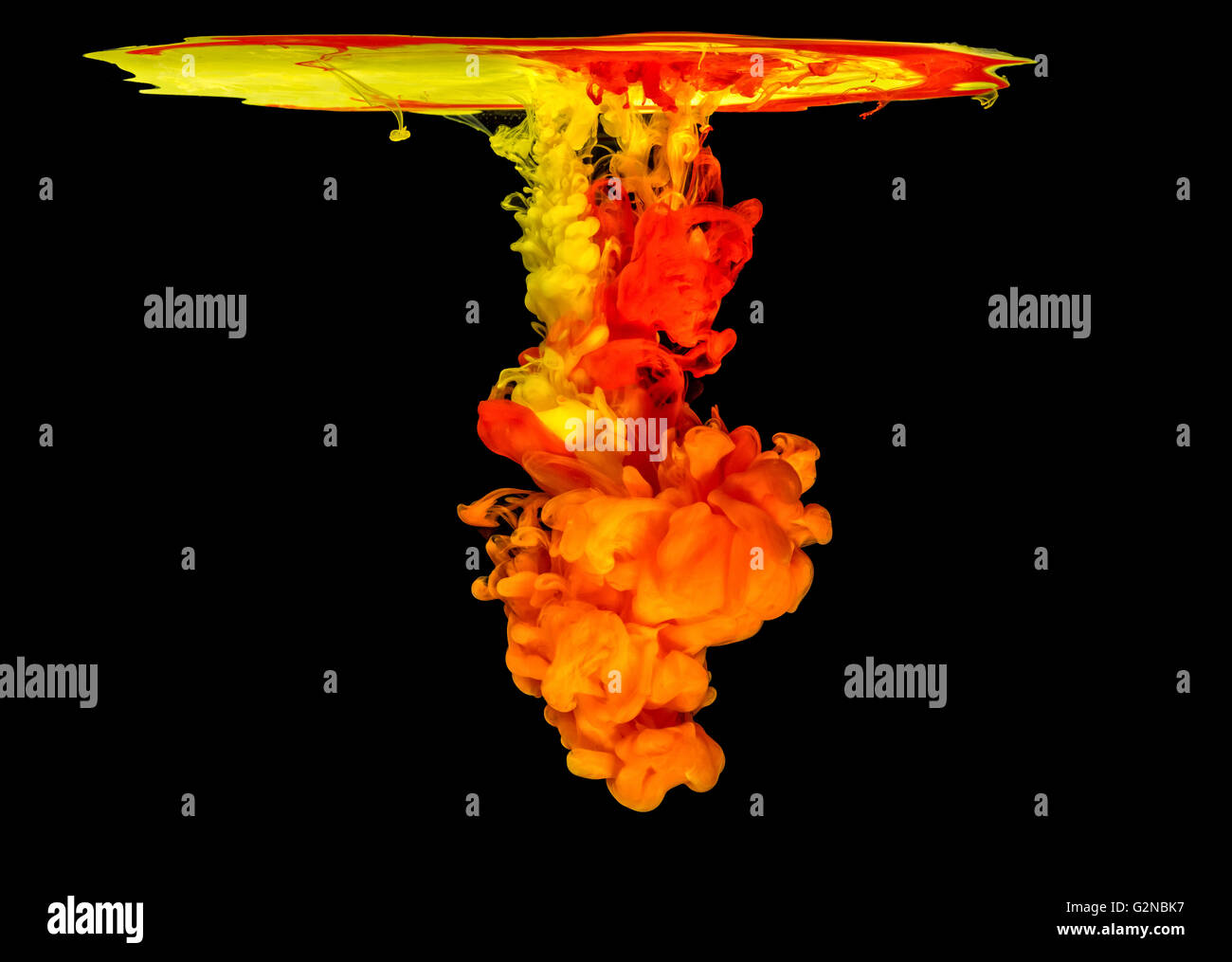 Mix of colored ink in water creating abstract shape, isolated on black ...