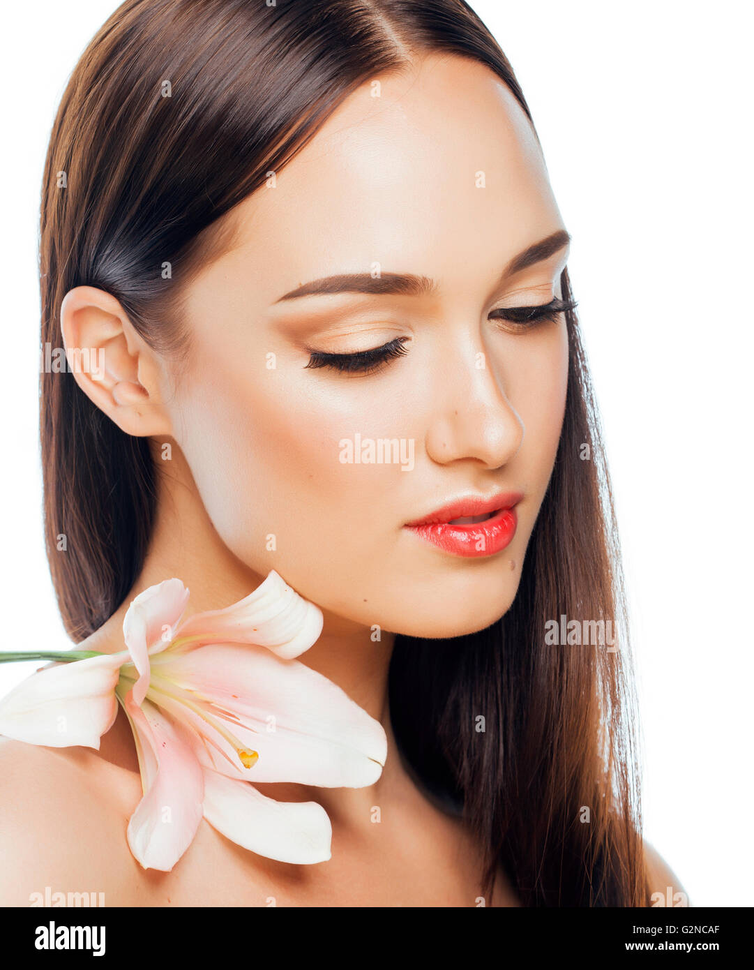 young attractive lady close up with hands on face isolated flower lily ...