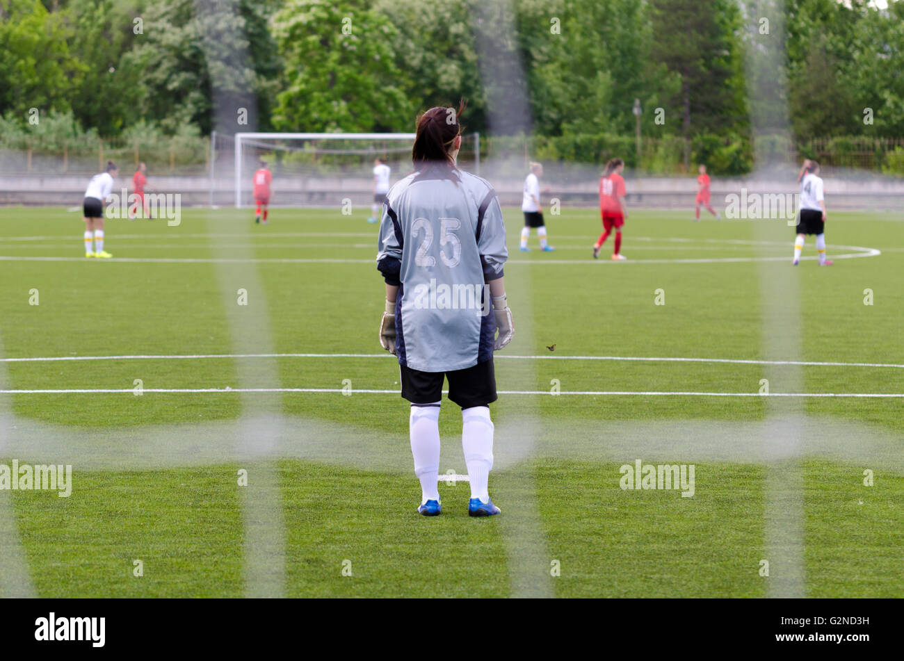 Woman with her back to goal Stock Photo - Alamy