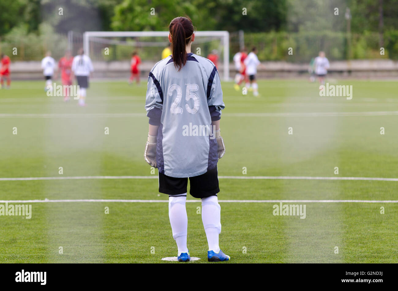 Woman with her back to goal Stock Photo - Alamy