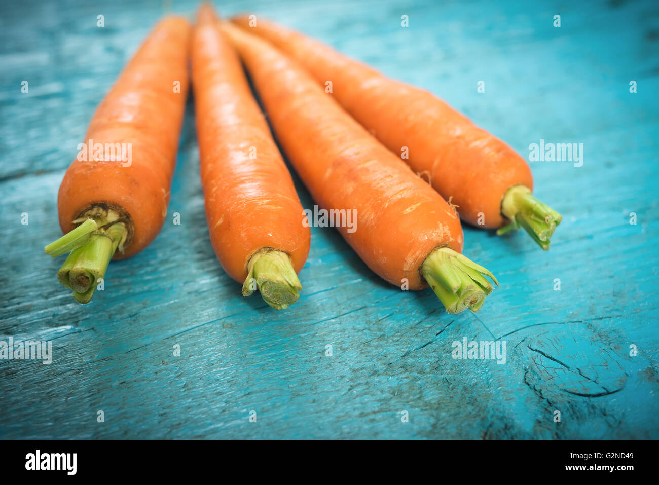 Carrot on the old boards Stock Photo - Alamy