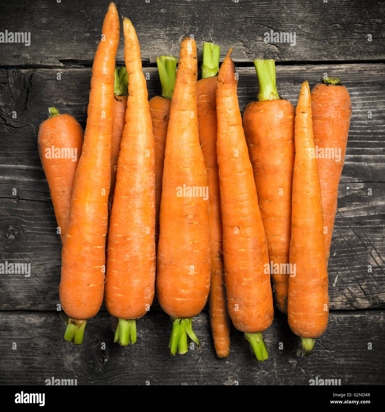 Carrot on the old boards Stock Photo - Alamy