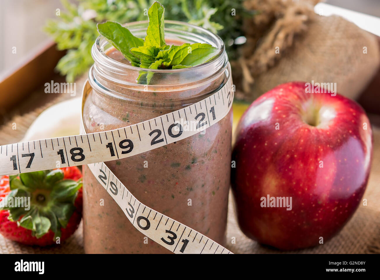 Meal replacement shake in a mason jar with a ruler tape wrapped around ...
