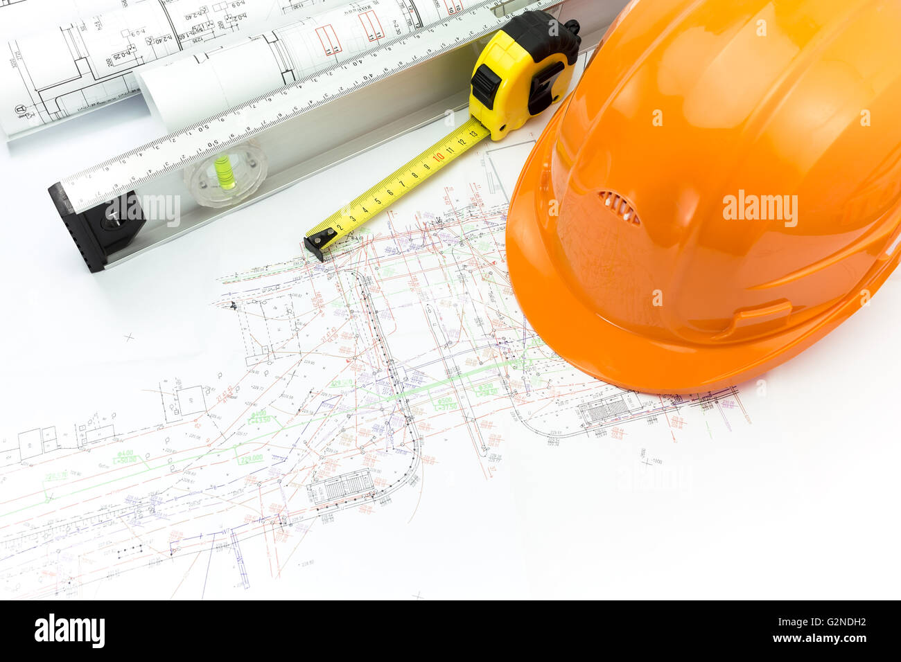 Protective helmet and tape measurement tools over architectural ...